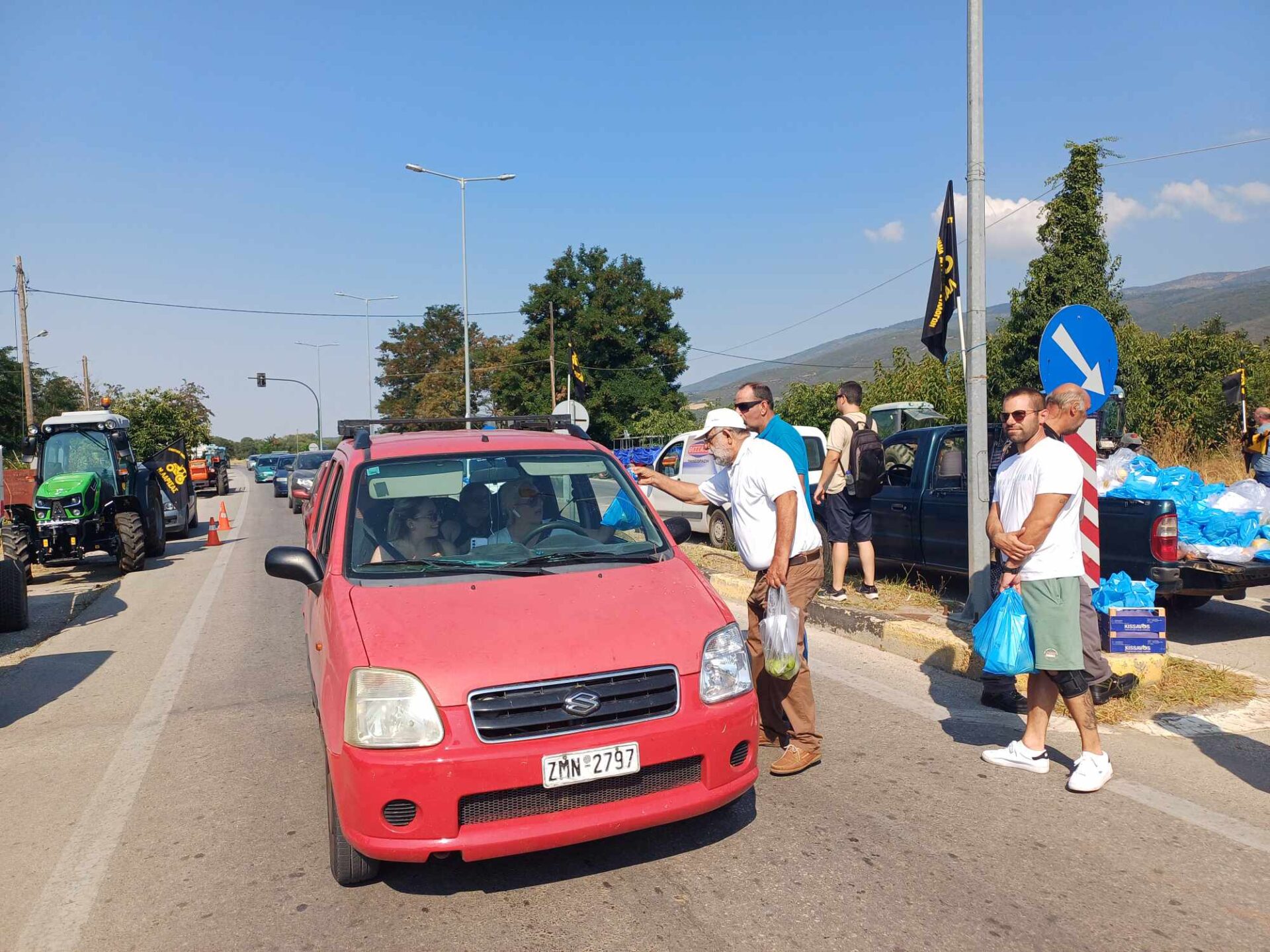 Εν μέσω καύσωνα έβγαλαν τρακτερ στην είσοδο της Αγιάς και μοίρασαν μήλα ...